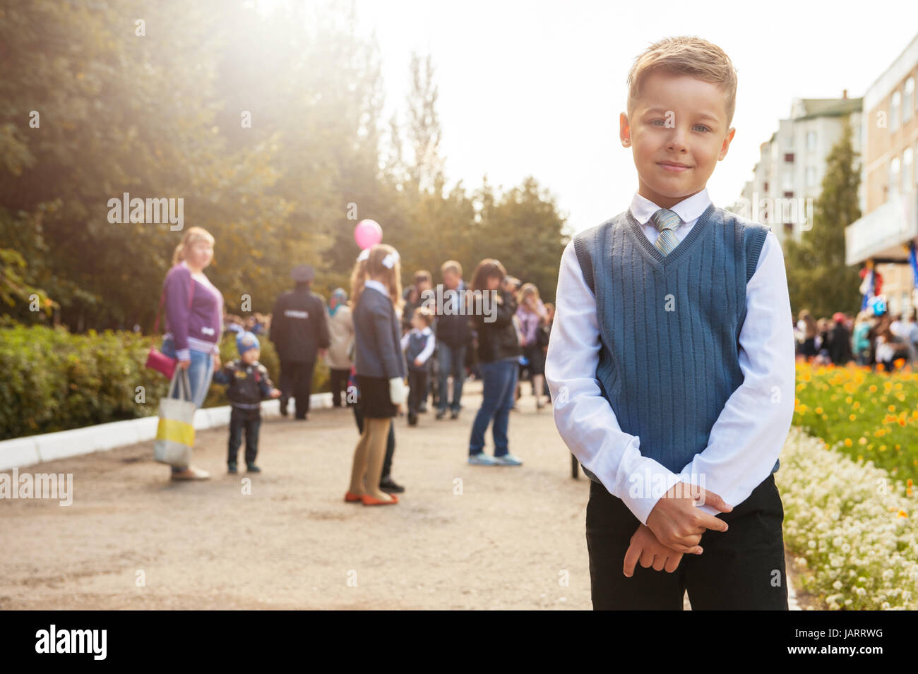 The first time in first class: happy schoolboy at school background ...