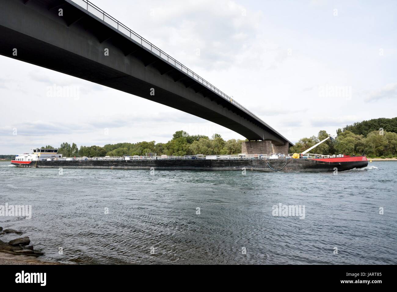 Transport ship under a bridge accross the river Rhine in Speyer ...