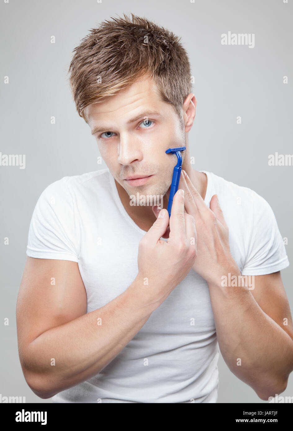 Portrait of a handsome man shaving Stock Photo - Alamy