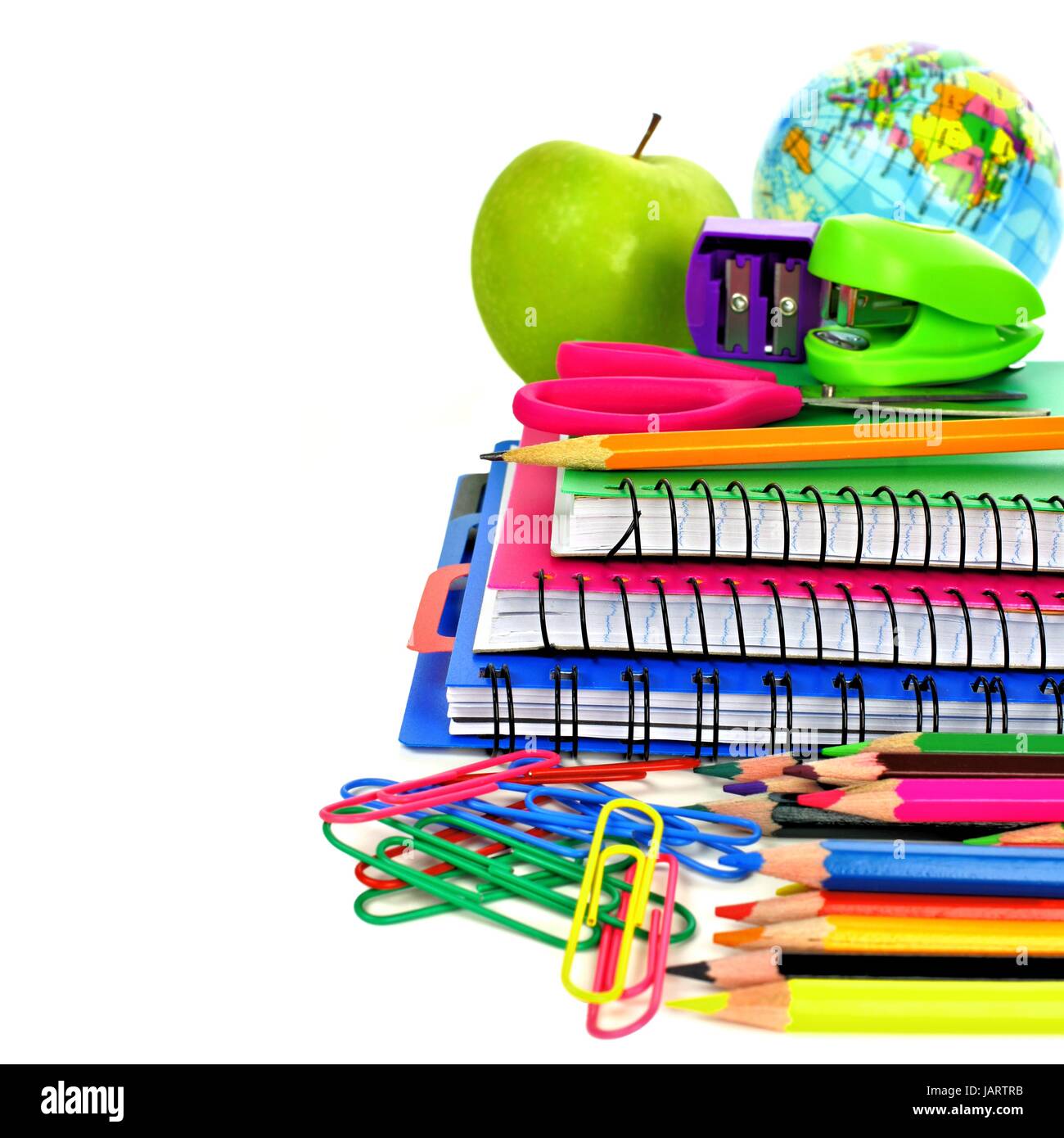 Group of colorful school supplies forming a border over a white ...
