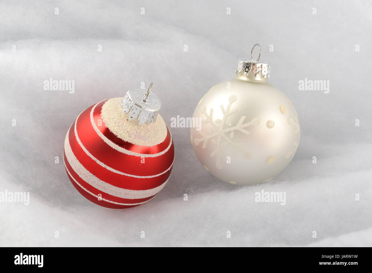 Christmas Baubles on snow white background Stock Photo - Alamy