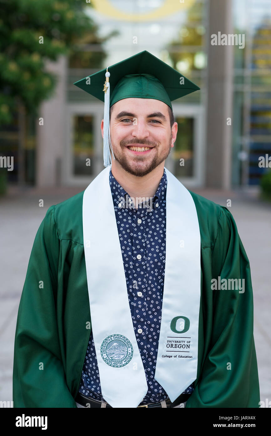 EUGENE, OR - MAY 23, 2017: Male college senior poses for graduation ...