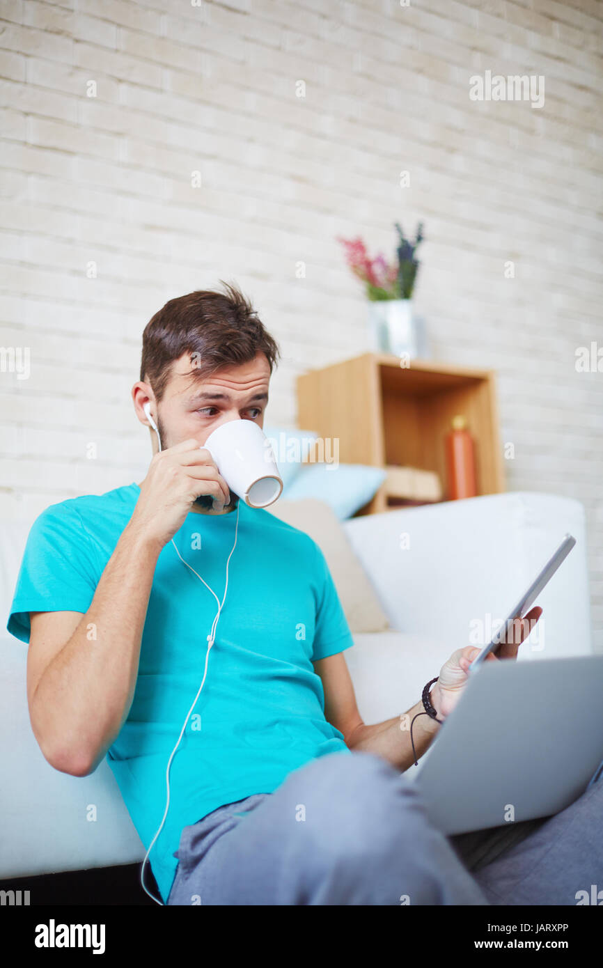 Multitasking man at home Stock Photo - Alamy
