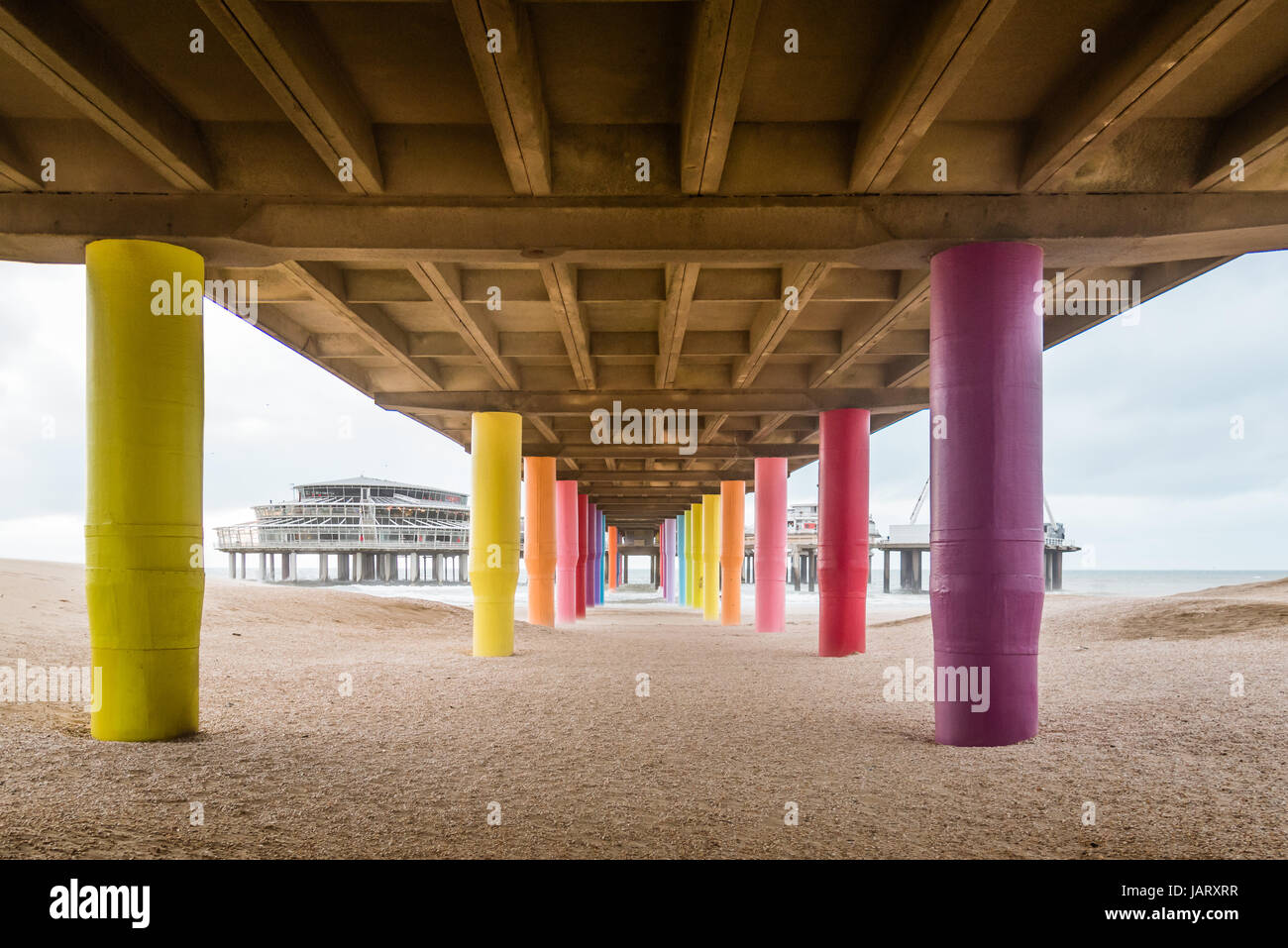 Shot under pier with color painted columns on the beach at sunset Stock ...