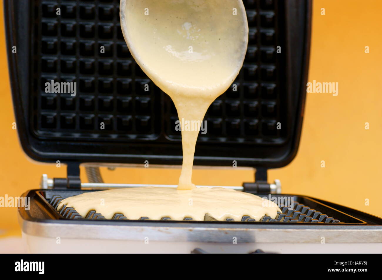 waffle pastry press in use in modern kitchen Stock Photo - Alamy