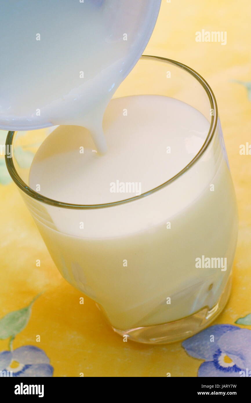 buttermilk in glass on kitchen table Stock Photo - Alamy