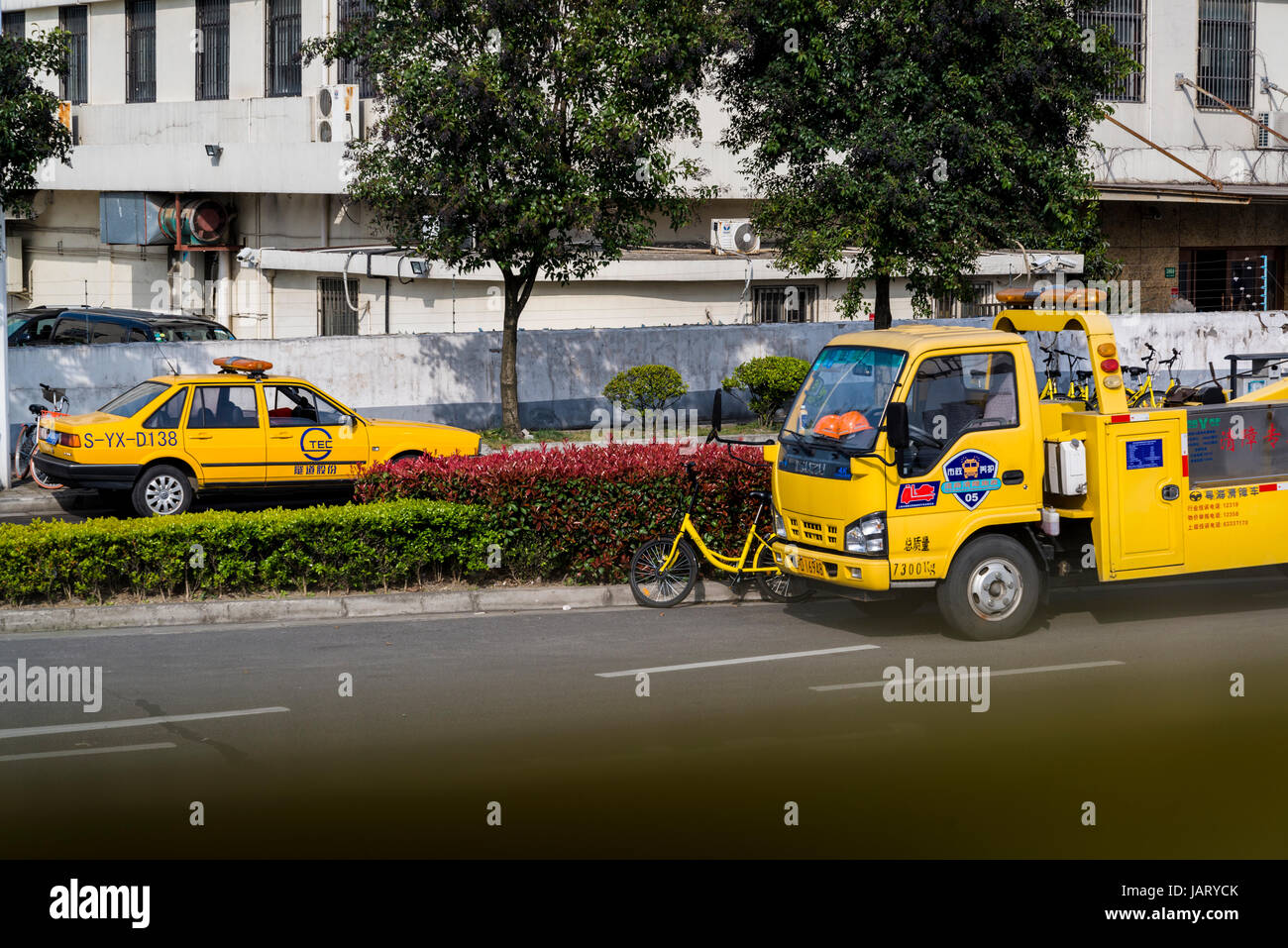 Two yellow vehicles, Shanghai, China Stock Photo - Alamy