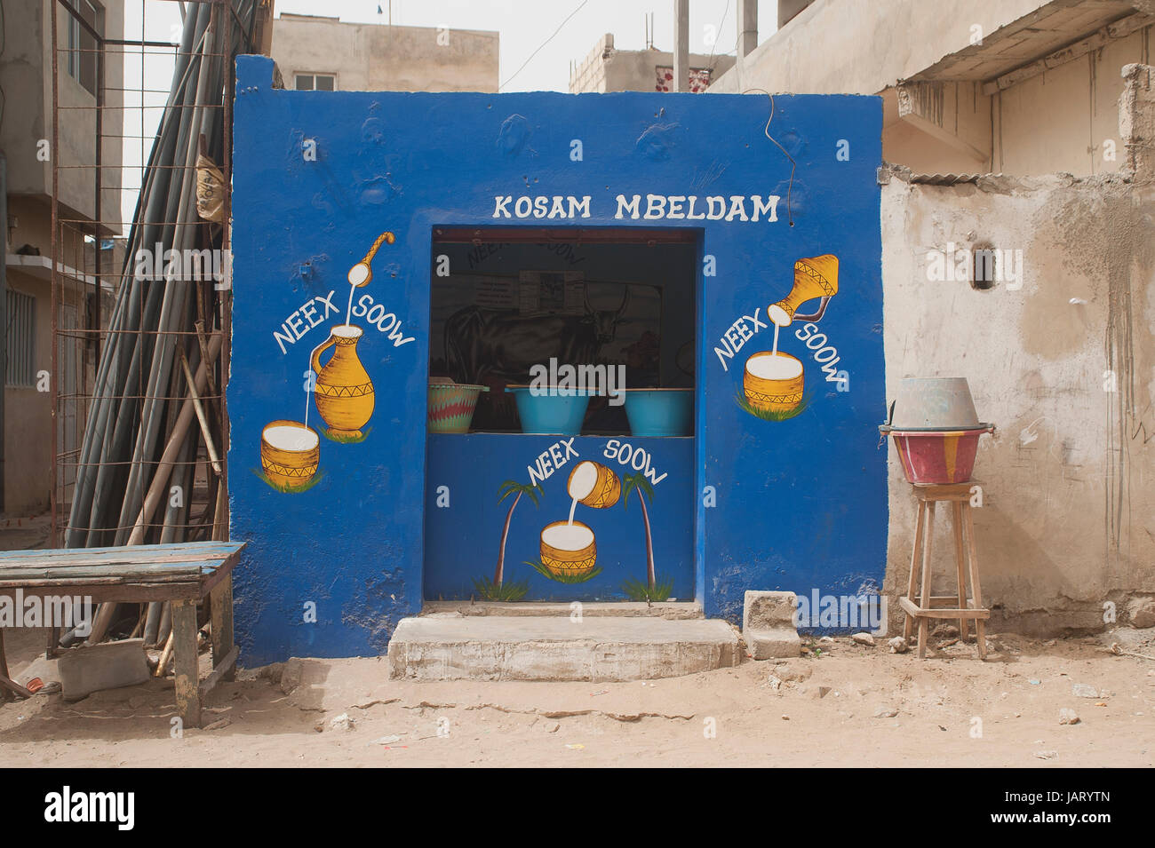 small basic shop in a back street in Dakar selling fresh milk with hand ...