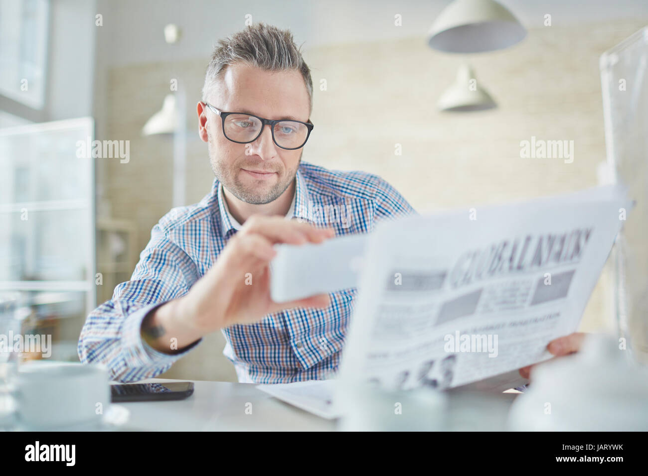 Office worker with newspaper Stock Photo - Alamy