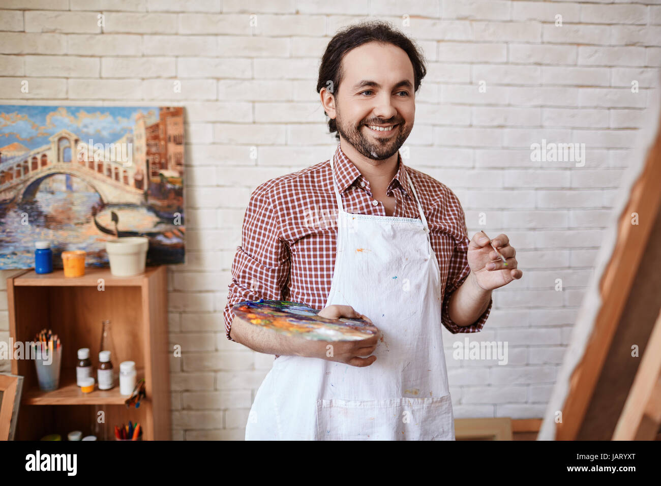 Artist Enjoying Work in Studio Stock Photo - Alamy