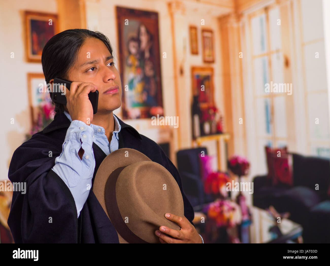 Close up portrait of handsome young indigenous man wearing hat and ...