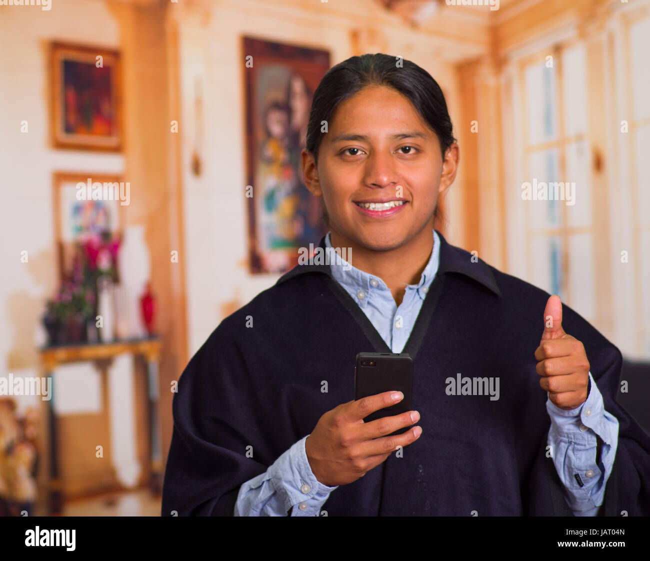Close up portrait of smiling handsome young indigenous man wearing hat ...