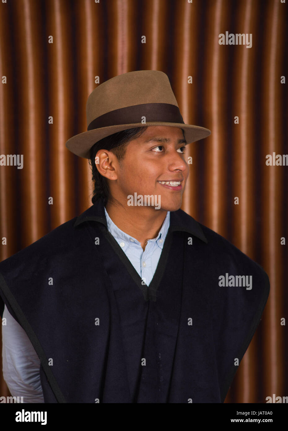 Close up portrait of smiling indigenous young man wearing traditional ...