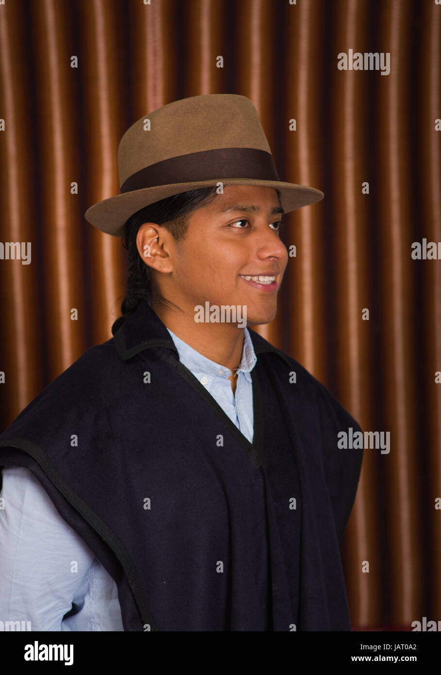 Close up portrait of smiling indigenous young man wearing traditional ...