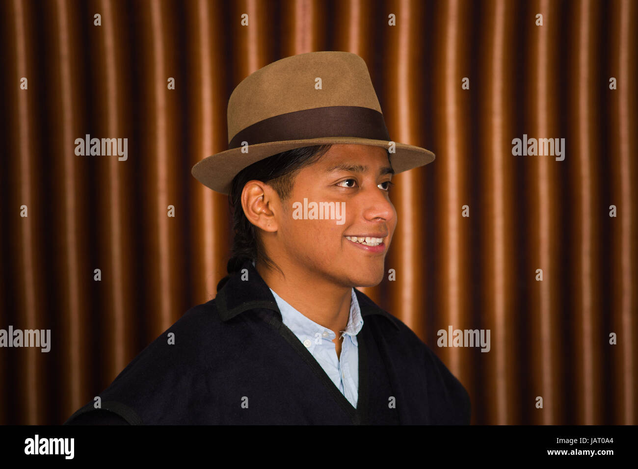 Close up portrait of smiling indigenous young man wearing traditional ...