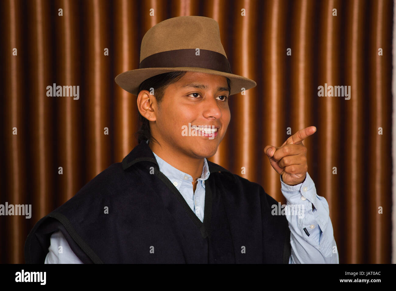 Close up portrait of indigenous young man wearing traditional hat and ...