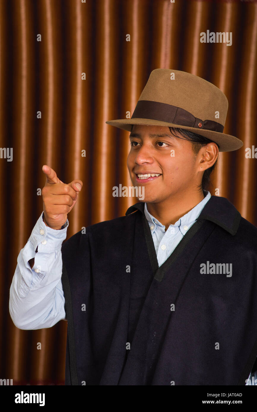 Close up portrait of indigenous young man wearing traditional hat and ...