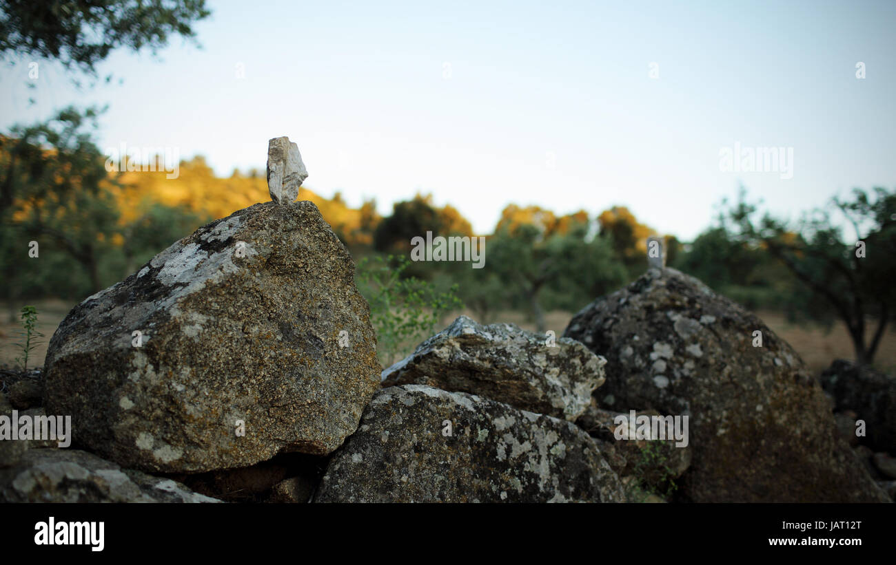 Details of a pebble in balance on rocks Stock Photo - Alamy