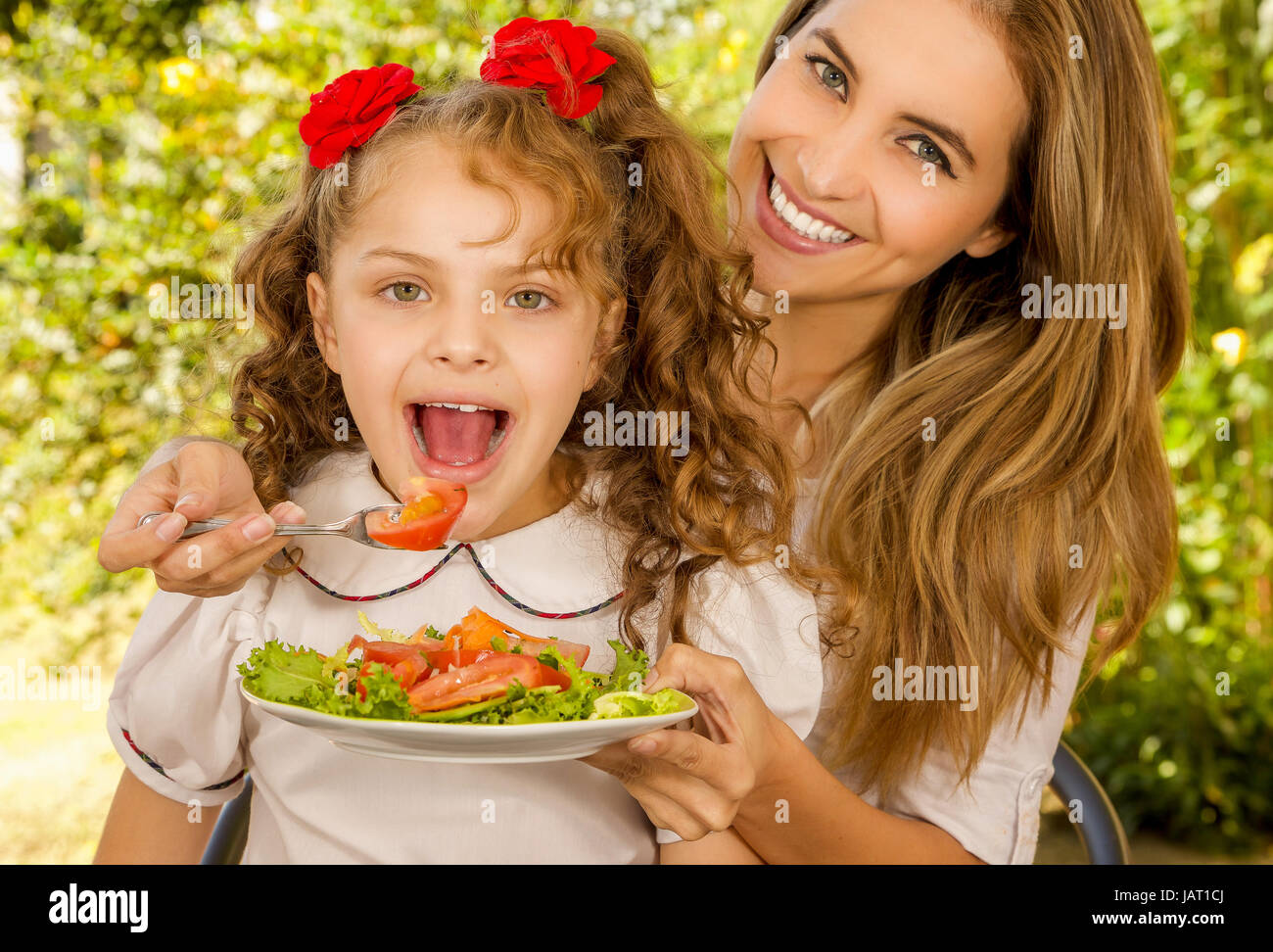 Mother and daughter having fun eating a healthy launch Stock Photo - Alamy