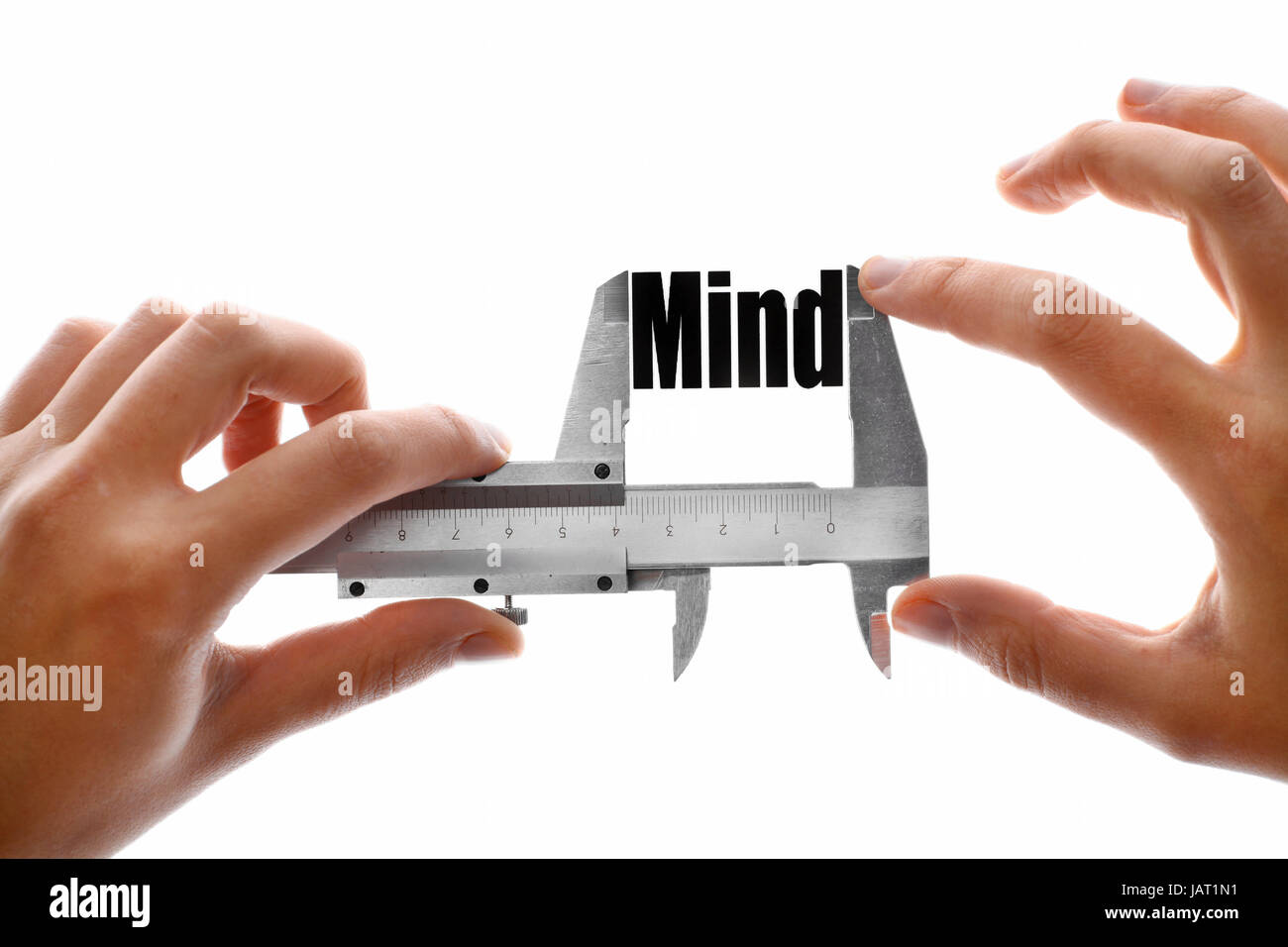 Two hands holding a caliper, measuring the word "Mind Stock Photo - Alamy