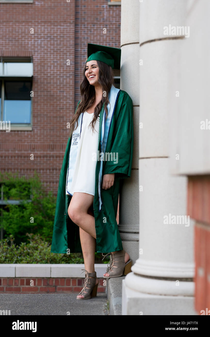 Pretty girl posing for a graduation photo on campus during her senior ...