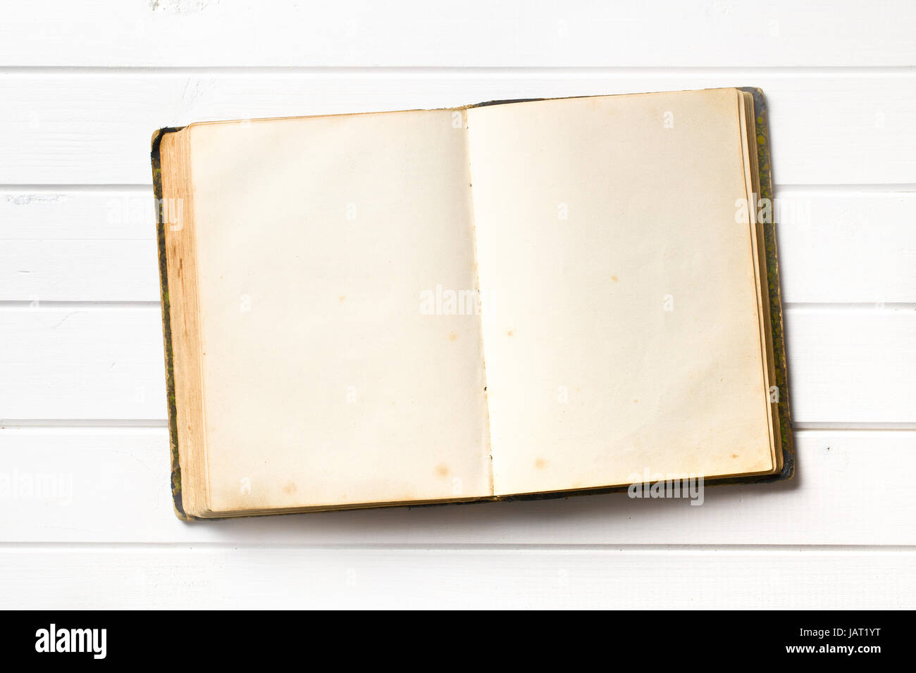 top view of old open book on white wooden background Stock Photo - Alamy