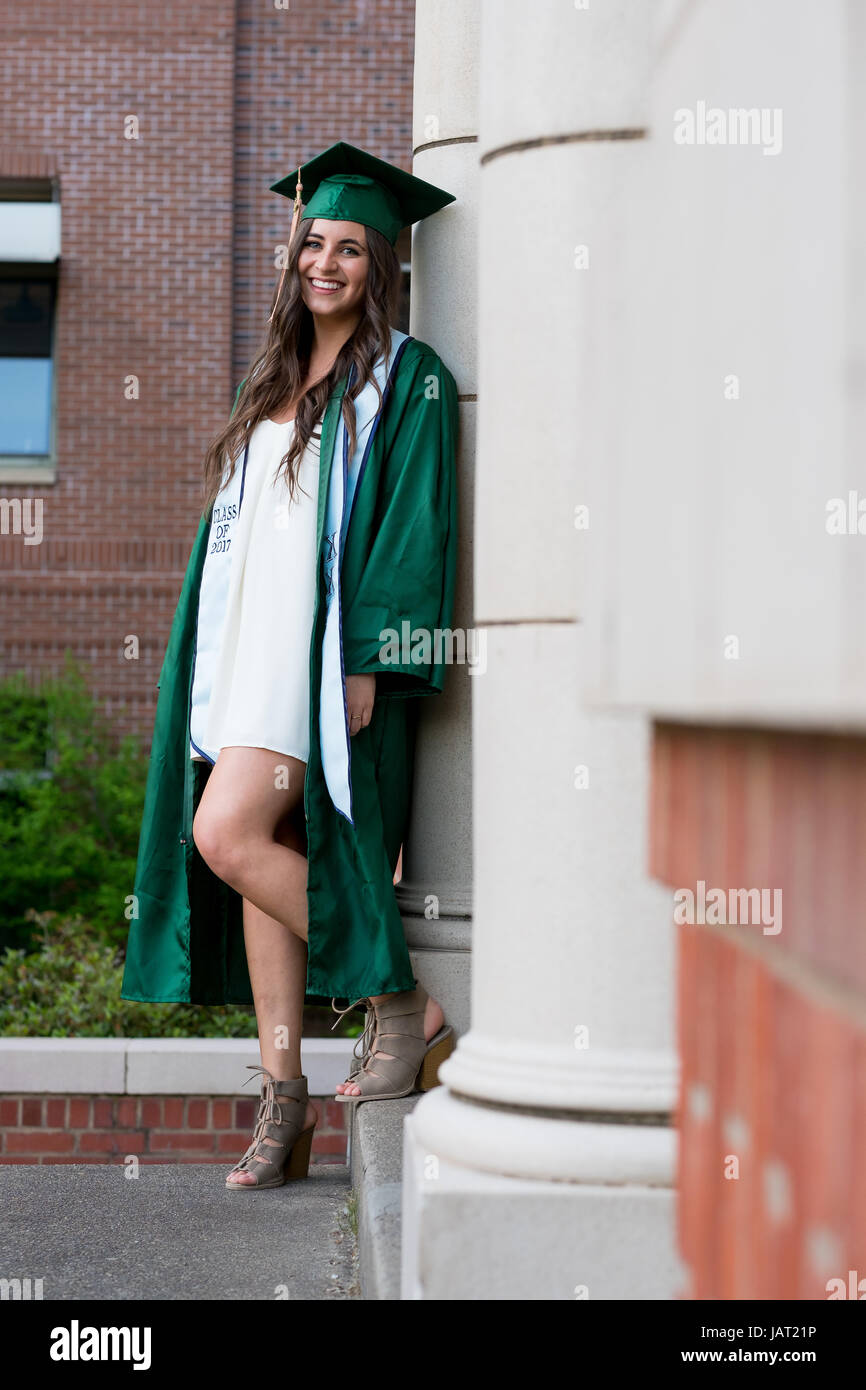 Pretty girl posing for a graduation photo on campus during her senior ...