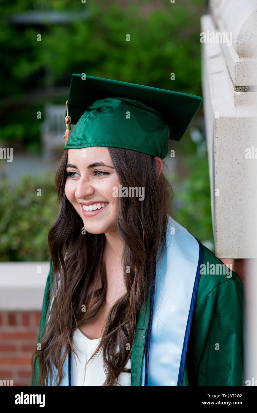 Pretty girl posing for a graduation photo on campus during her senior ...