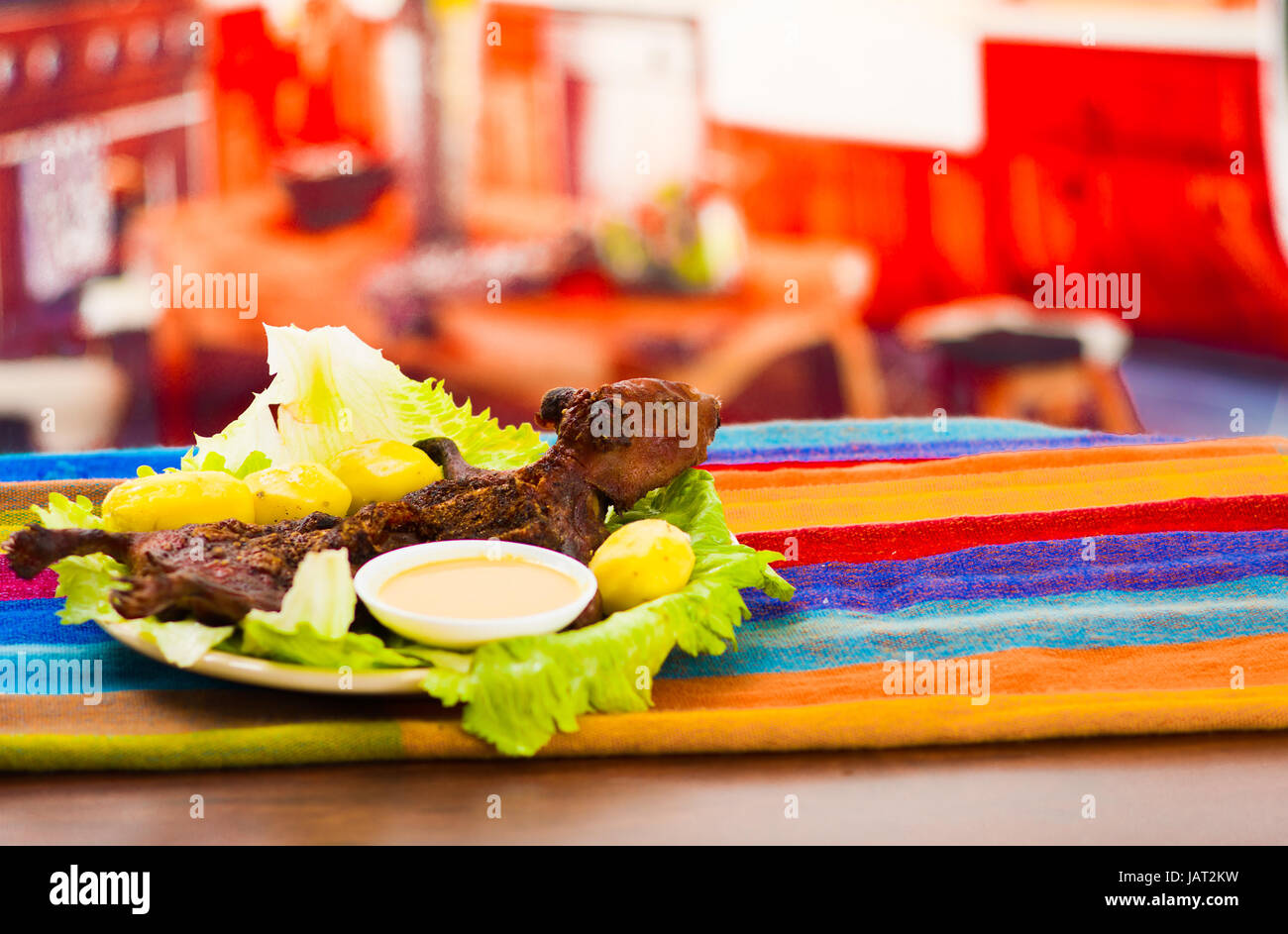 Traditional ecuadorian dish, grilled guinea pig spread out onto green ...