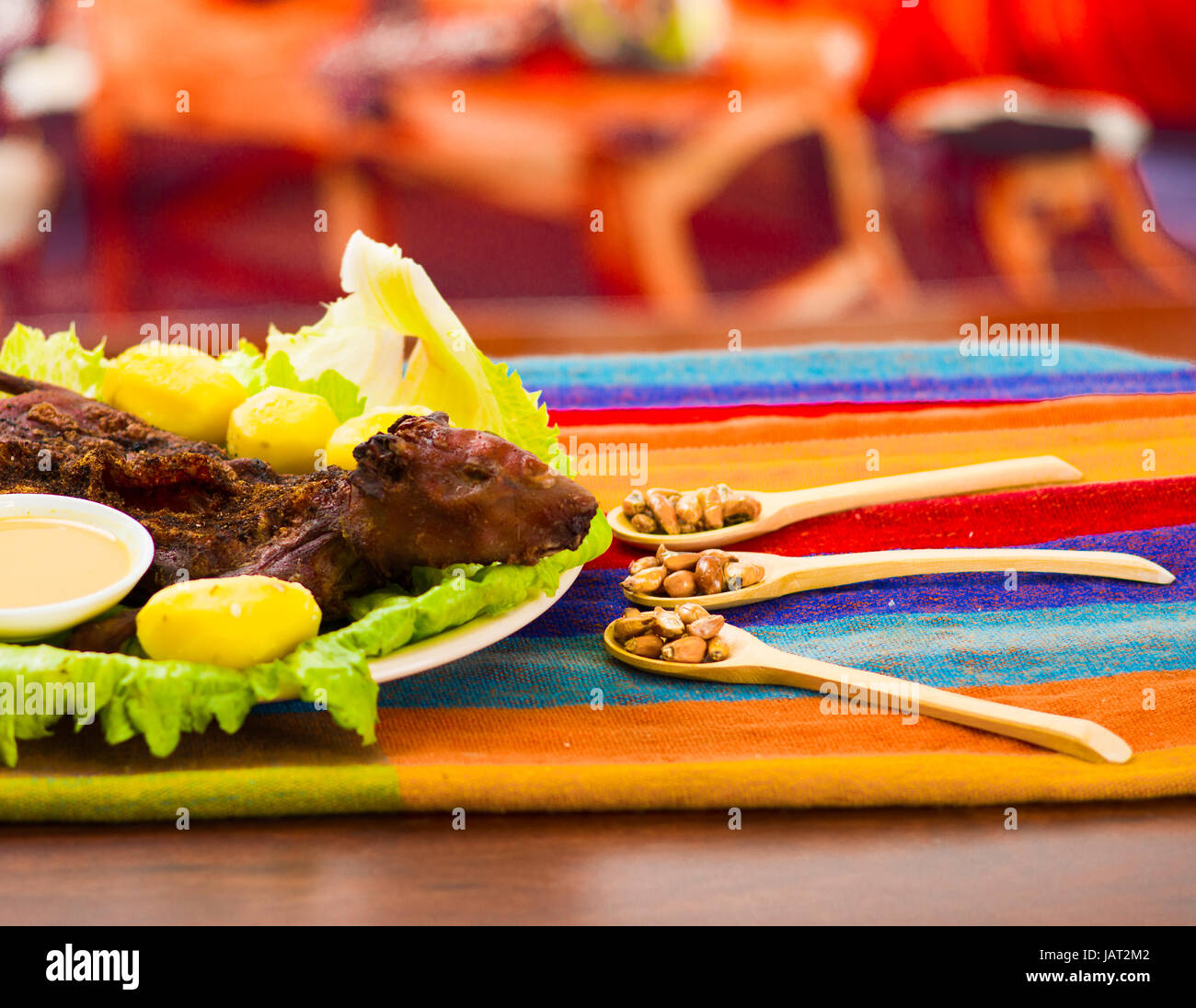 Traditional ecuadorian dish, grilled guinea pig spread out onto green ...