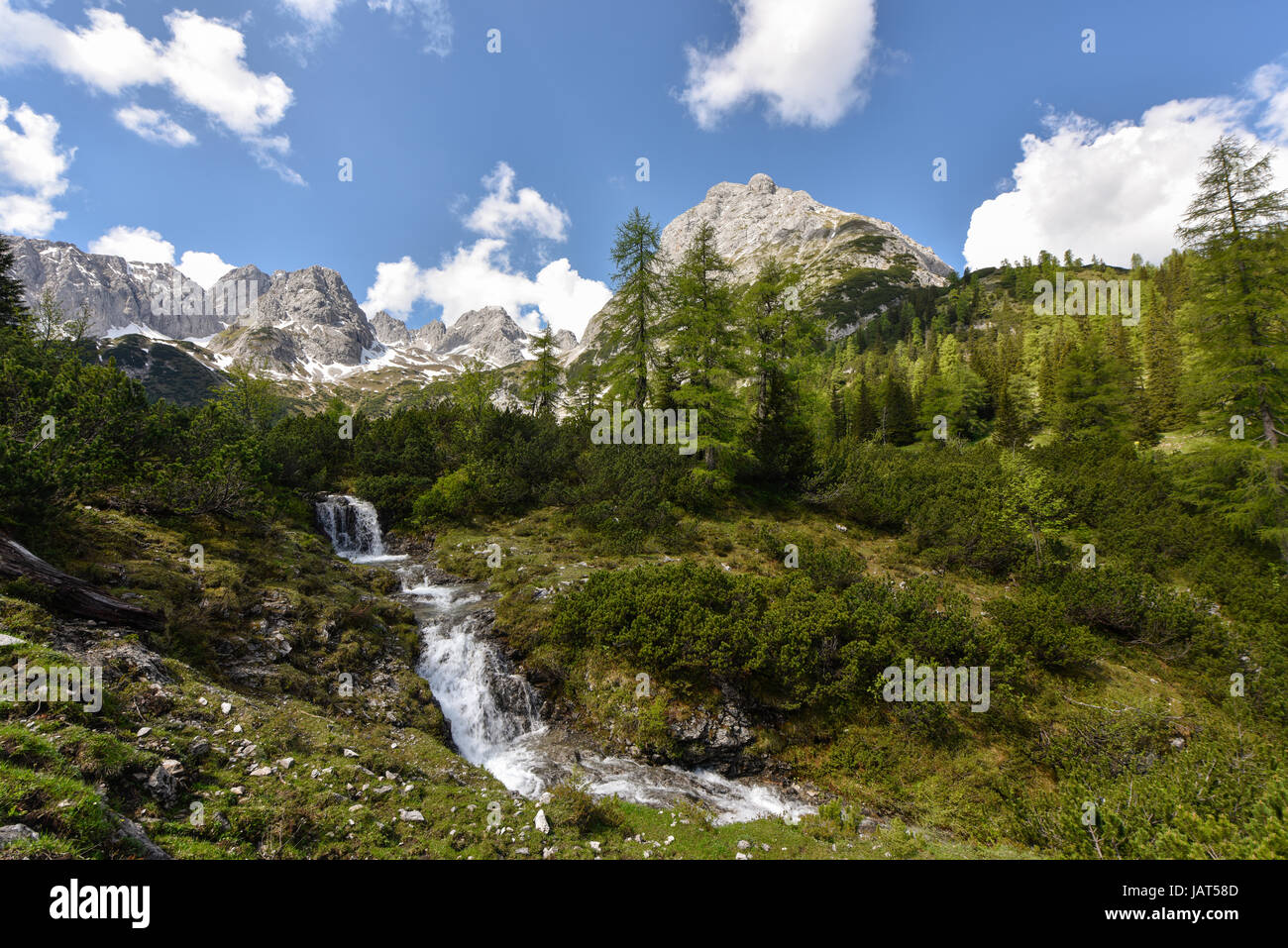 Waterfall at lake Seebensee with mountain range in the background ...