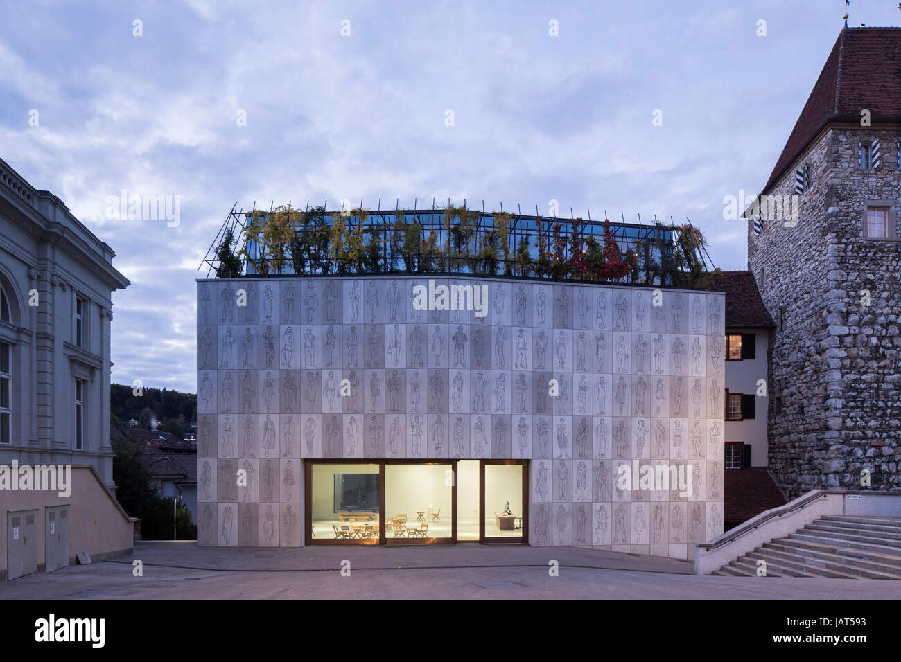 Dusk view of extension's engraved concrete facade. Aarau City Museum ...