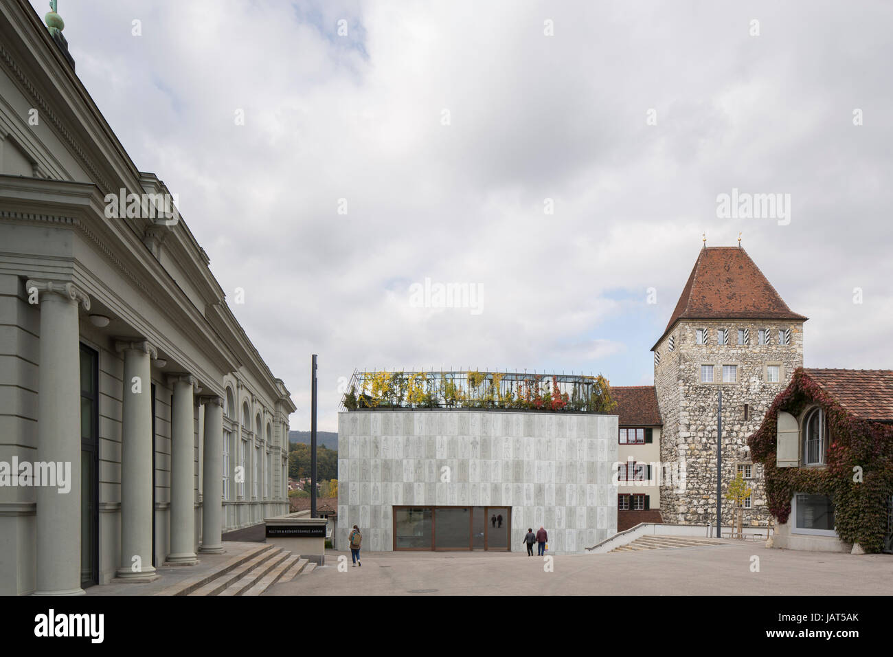 Front elevation of extension's engraved concrete facade nestled between ...