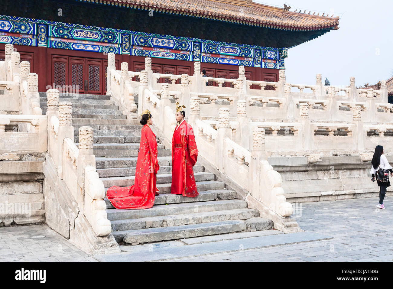BEIJING, CHINA - MARCH 19, 2017: couple in red dresses on steps of Hall ...