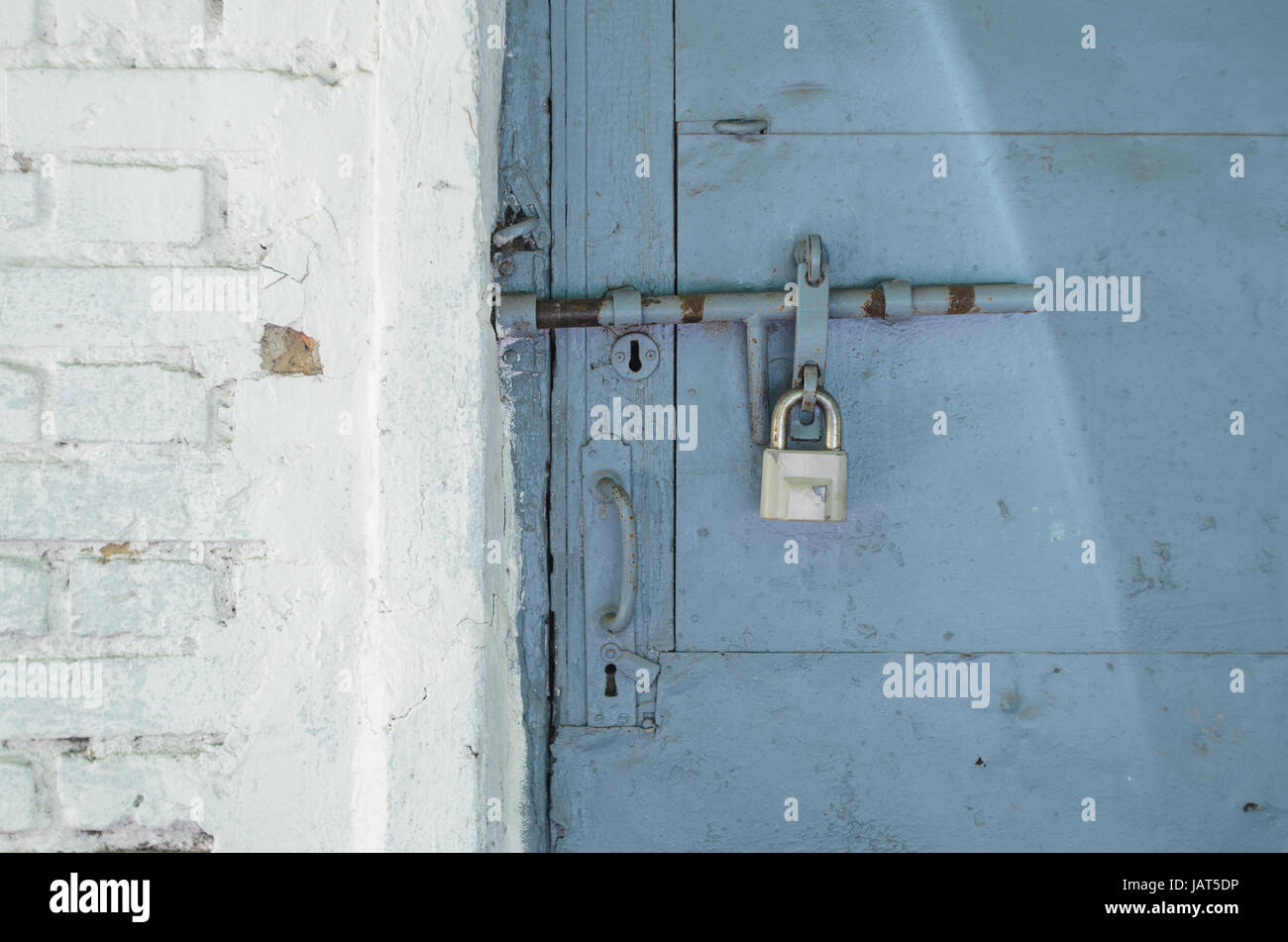 Padlock on the blue metal door. Locked on the castle is an old door in ...