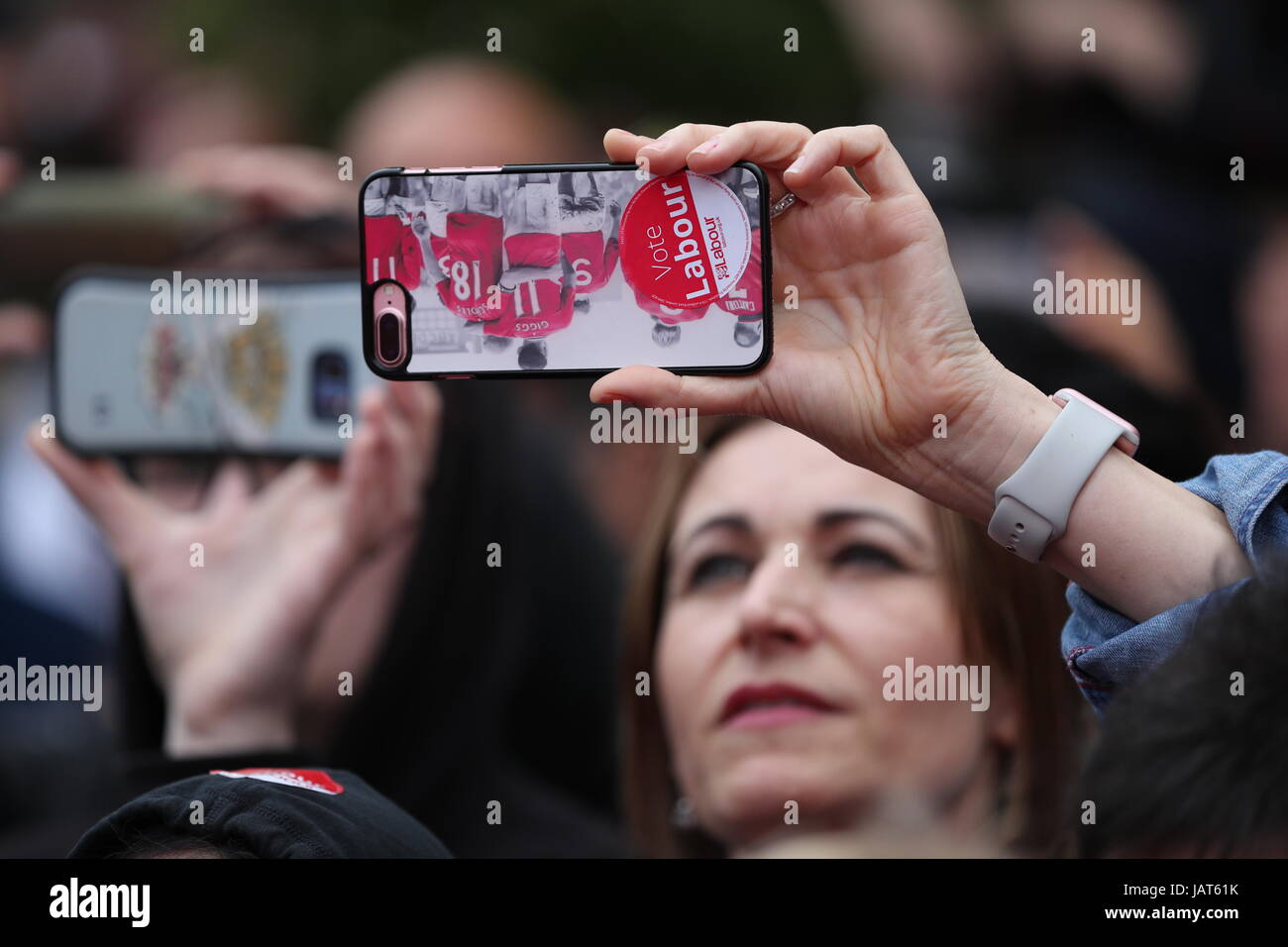A supporter films on her mobile phone during an appearance by Labour ...