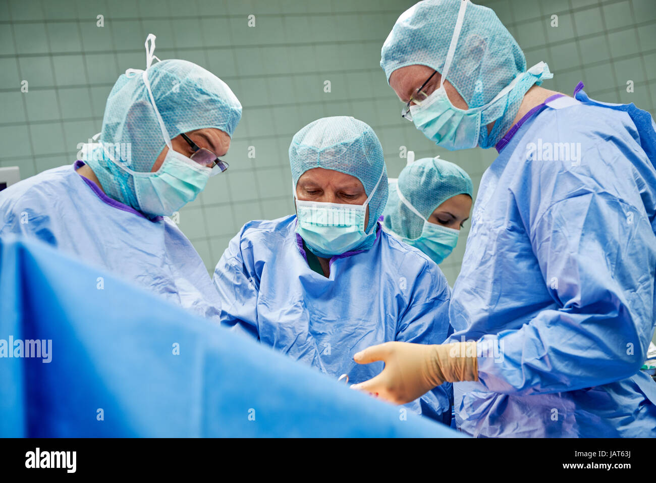 team of surgeons and nurses performing laparoscopic minimally invasive ...