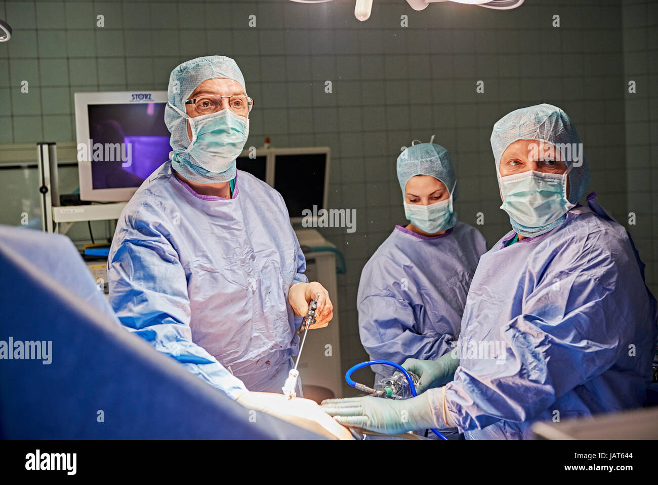 Surgeons performing endoscopic surgery hi-res stock photography and ...
