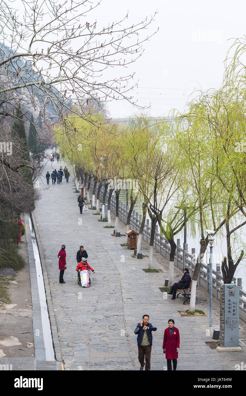 LUOYANG, CHINA - MARCH 20, 2017: visitors on embankment of Yi river on ...