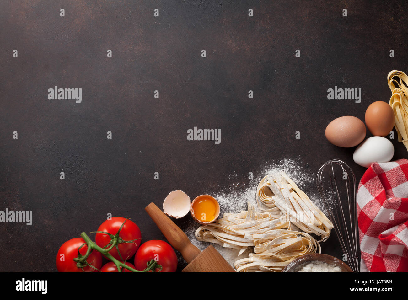 Pasta cooking ingredients on kitchen table. Top view with space for ...