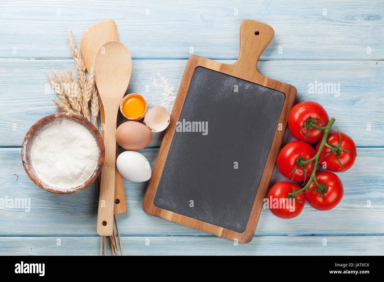 Pasta cooking ingredients on wooden kitchen table. Top view with ...