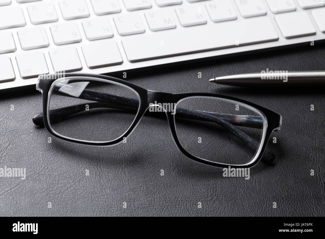 Office desk with eyeglasses, computer and supplies Stock Photo - Alamy