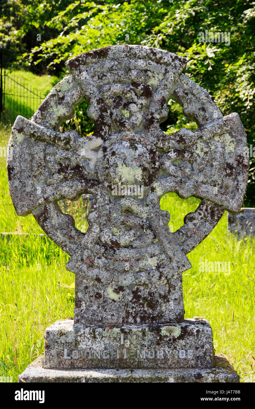 Lichen encrusted Celtic cross memorial stone in a Cornish graveyard ...