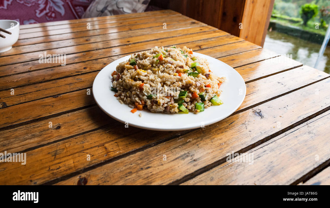 travel to China - plate with fried rice with vegetables in rustic ...