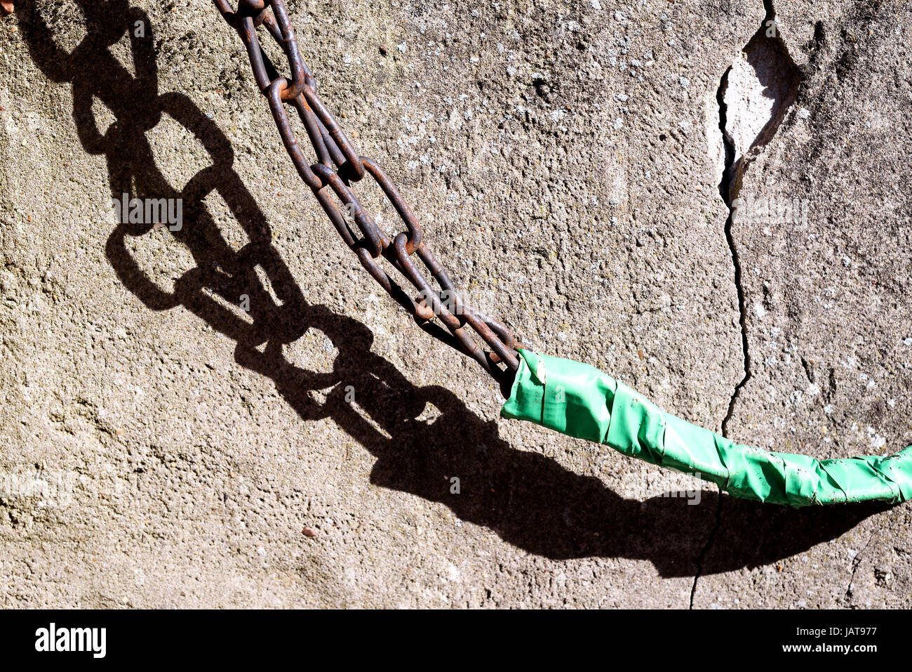Old rusty chain and cement facade brick wall with copy space area for ...