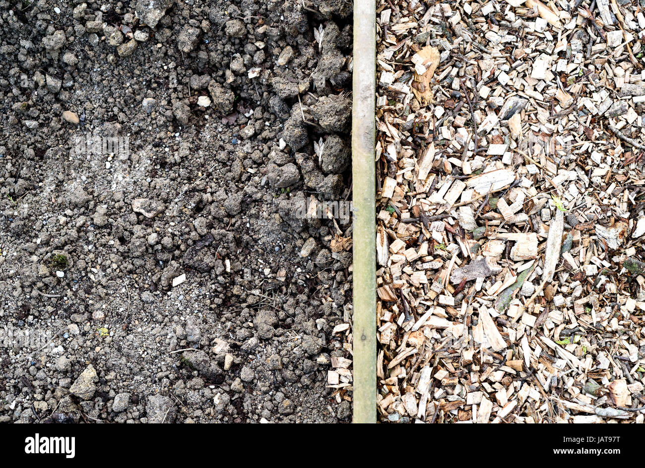 Dry garden soil and a wood chipping path with a wooden divider Stock ...