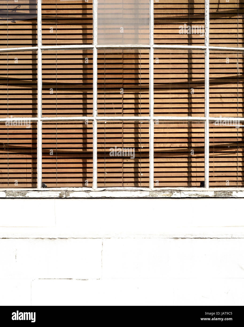 Old wooden venetian blinds behind a glass window on a white wall Stock ...