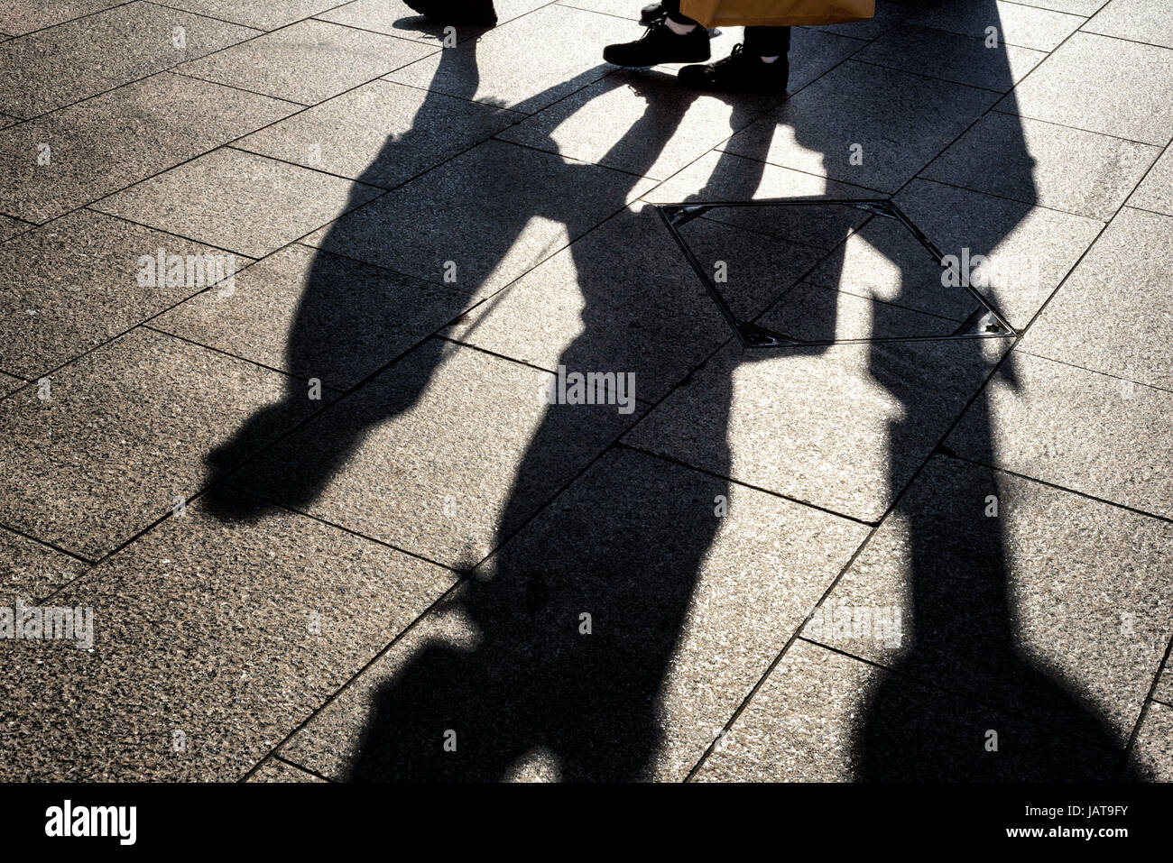 Shadows from feet and legs of people walking in sunlight Stock Photo ...