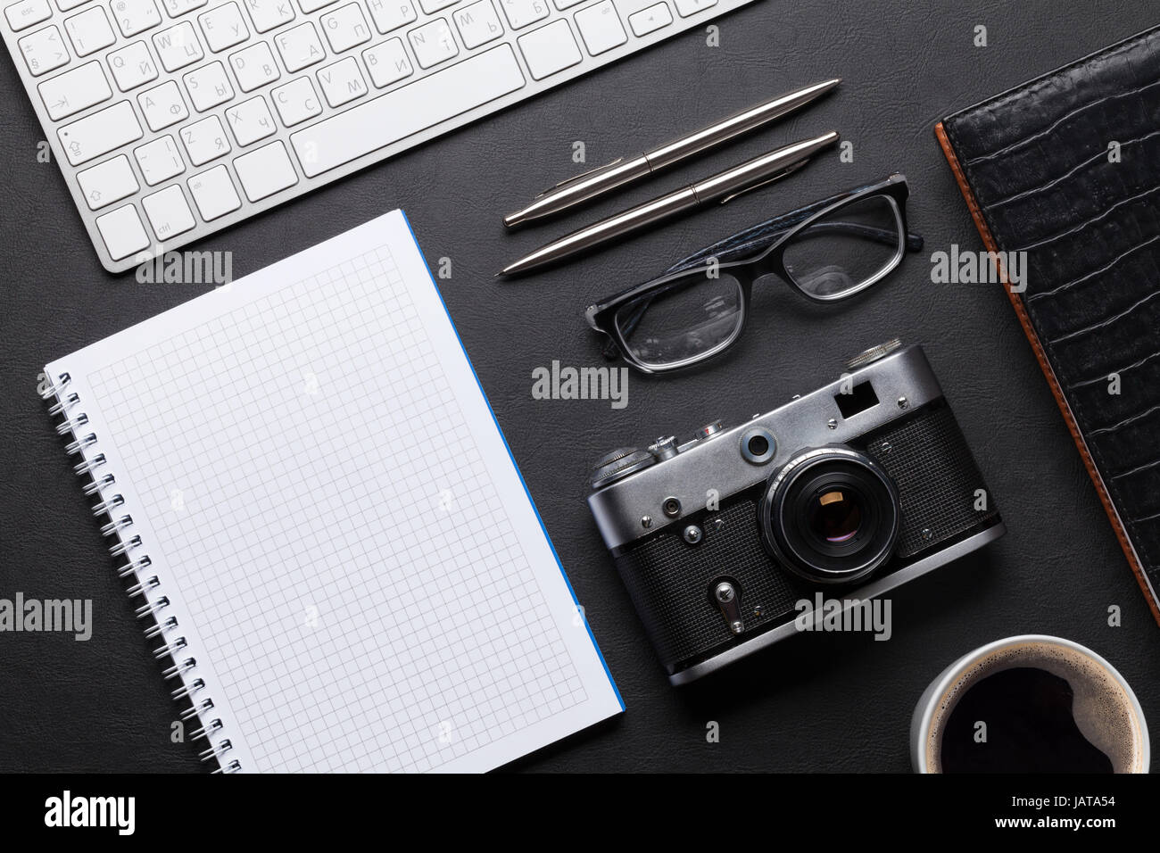 Office desk with photo camera, pc, notepad, glasses, pen and pencil ...