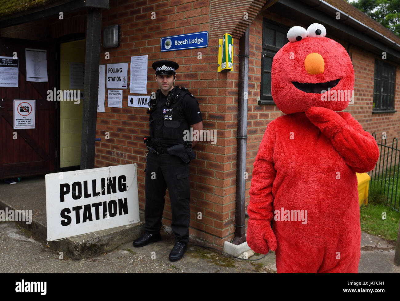 Police and a man dressed as Elmo outside a polling station in the ...